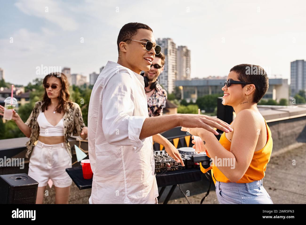 multicultural good looking friends with sunglasses drinking and having ...