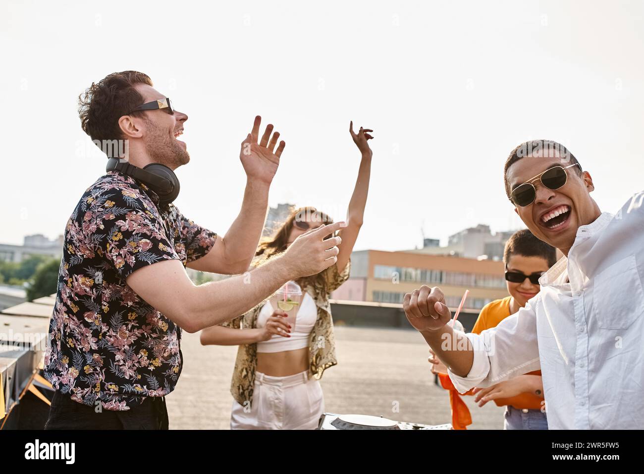 joyous multicultural friends with stylish sunglasses partying to DJ set ...