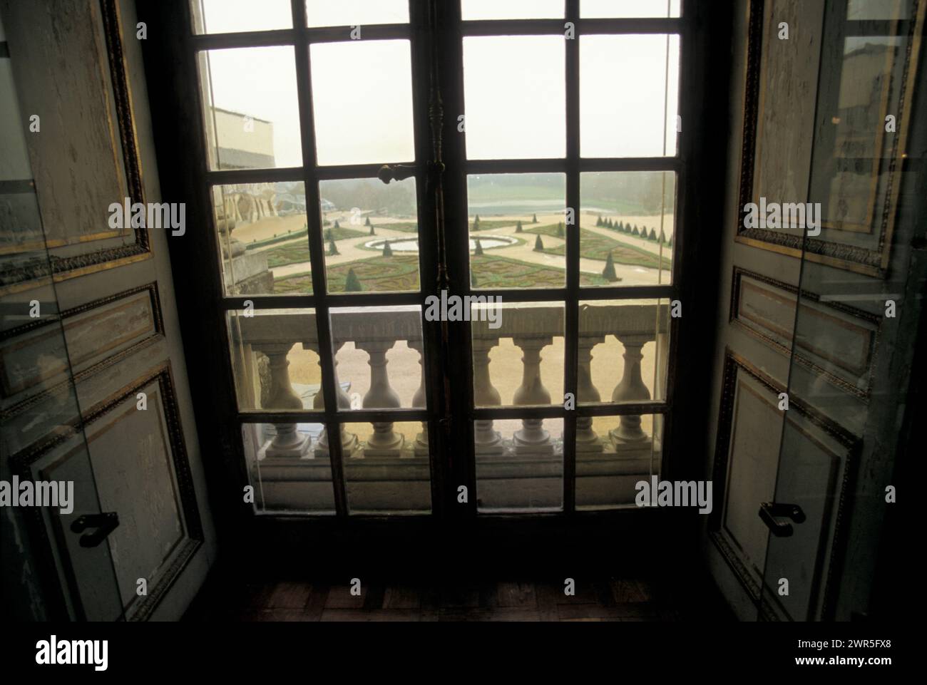 Looking out a window at the Palace of Versailles in the outskirts of ...