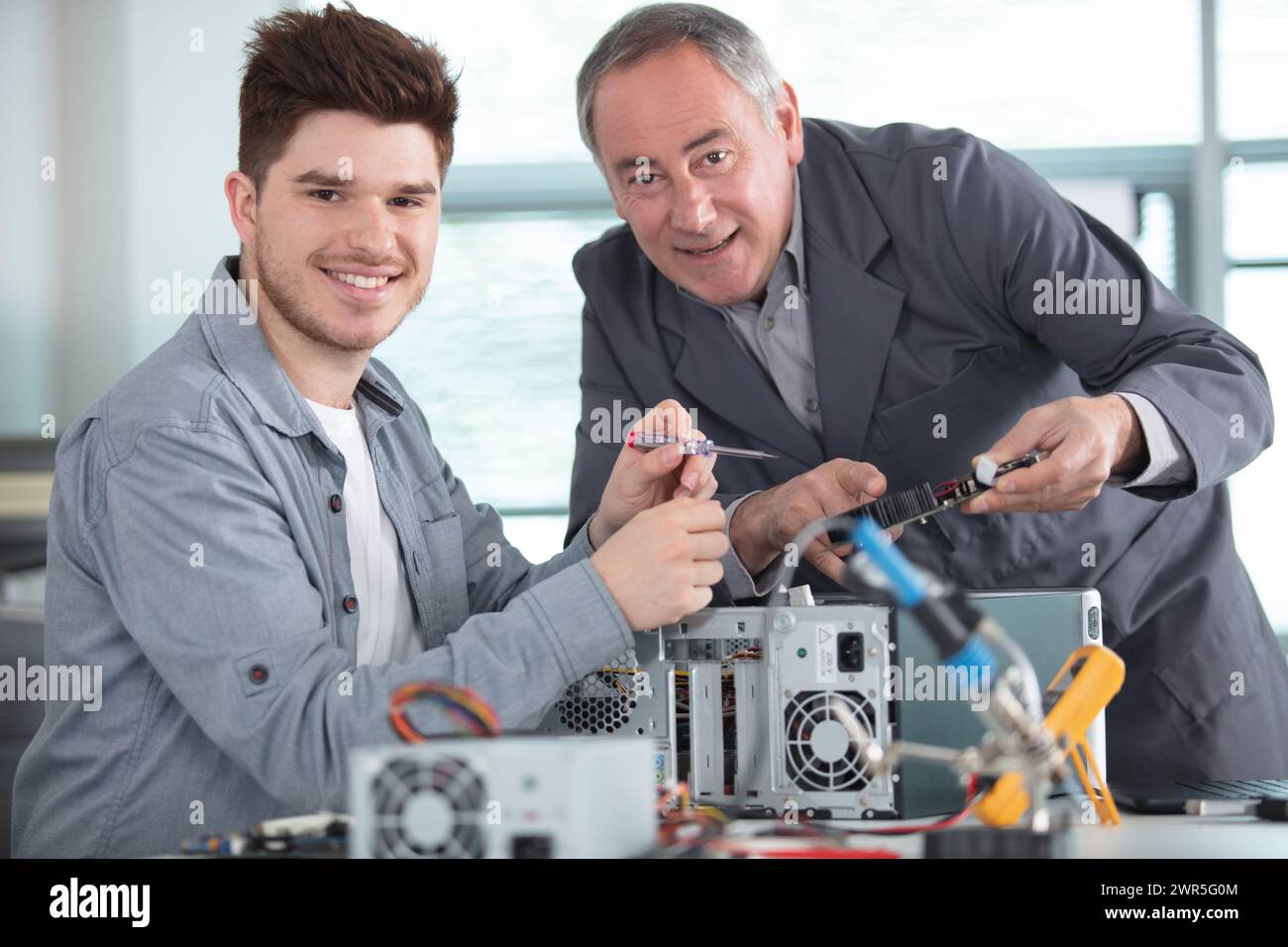 two men are engaged in assembling a desktop computer Stock Photo - Alamy
