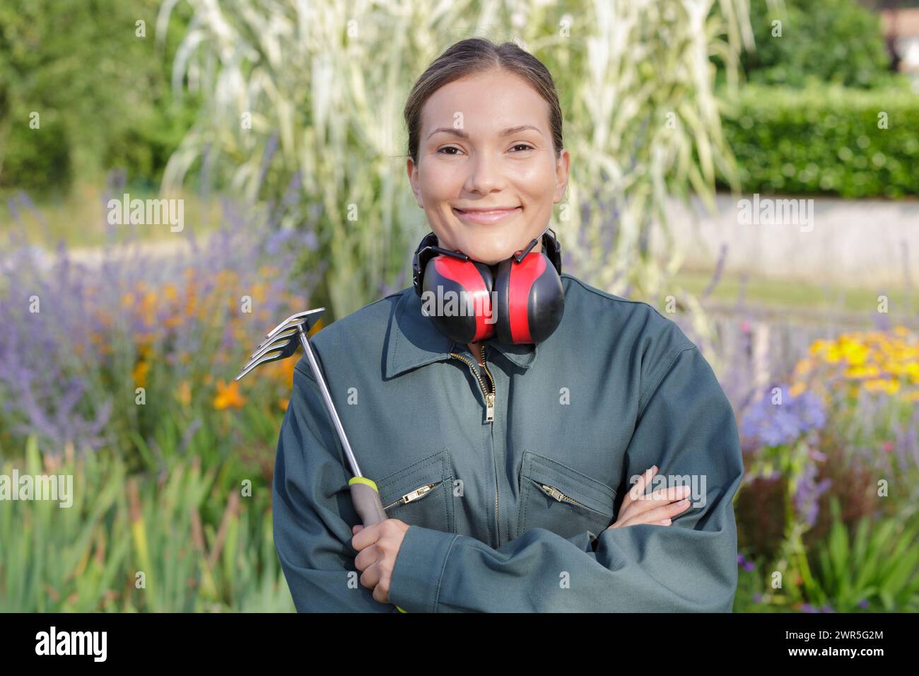portrait of professional female gardener holding rake Stock Photo - Alamy