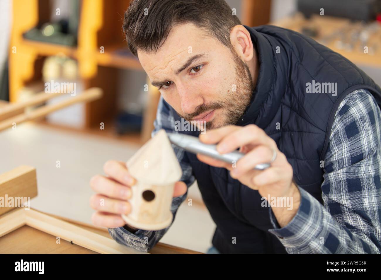 carpenter man building bird house Stock Photo - Alamy
