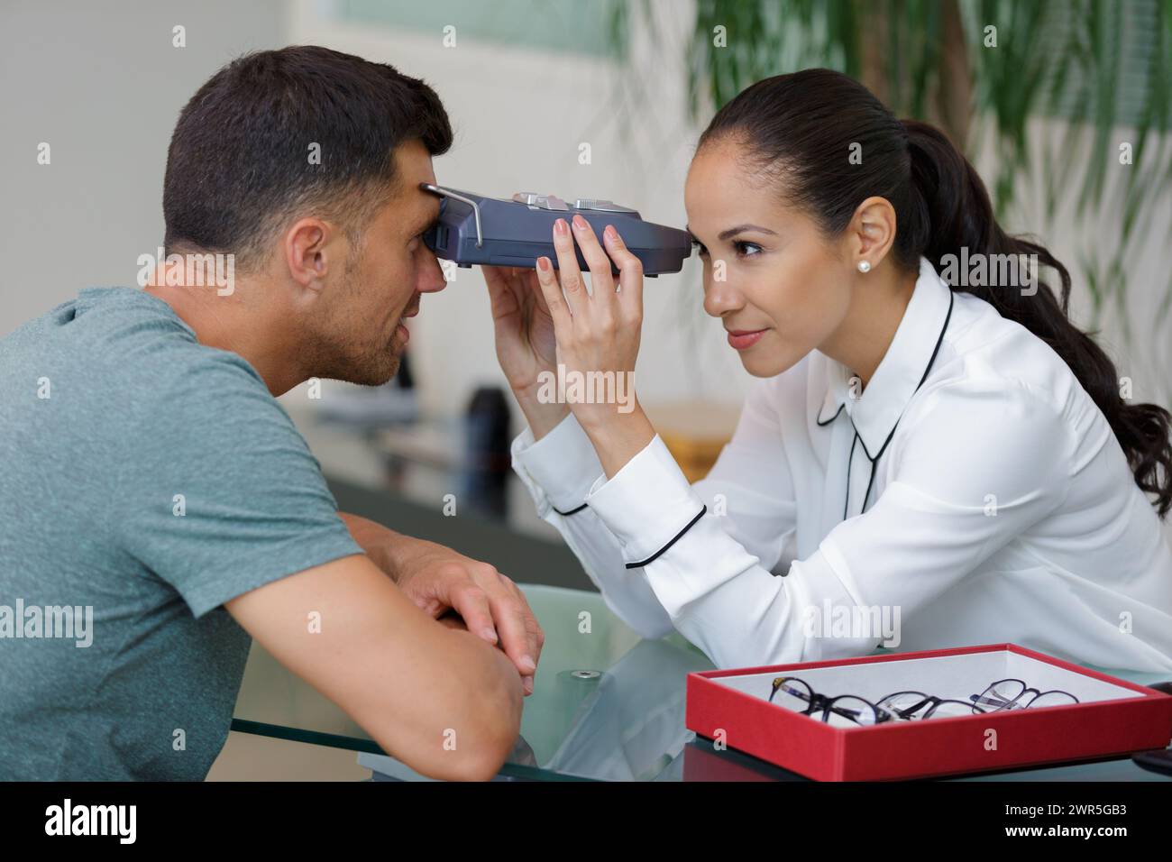 ophthalmologist examining mans eyes in medical center Stock Photo - Alamy