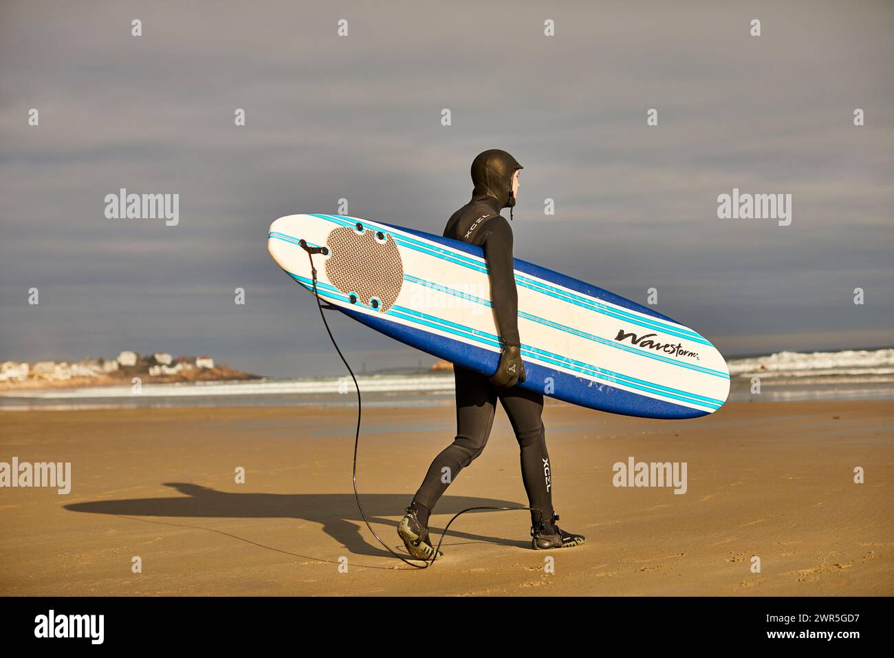 A Surfer Walking With His Surfboard At Good Harbor Beach In Gloucester ...