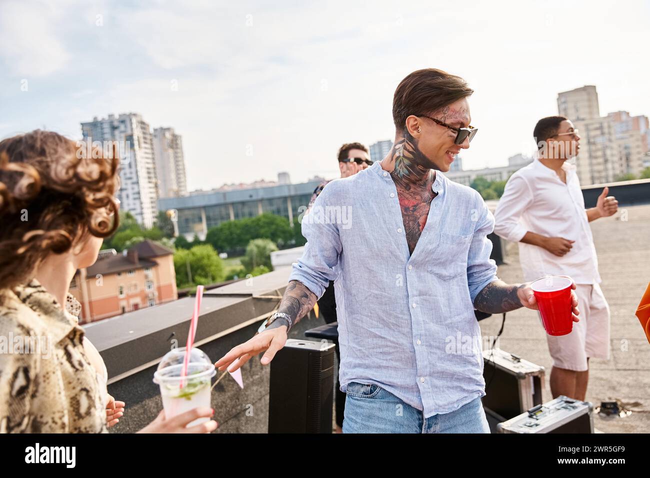 joyous multiracial friends with sunglasses drinking alcohol at rooftop ...