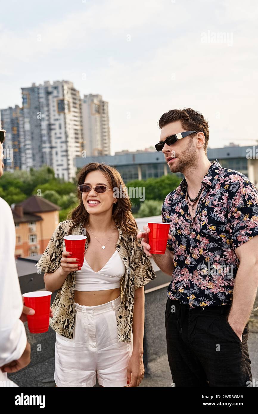 good looking jolly diverse friends with red cups with drinks talking ...