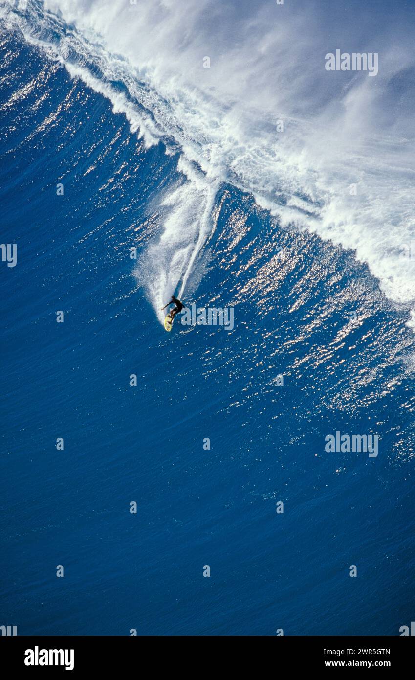 Man tow-surfing at Phantoms, an outer reef, off the north shore of Oahu ...