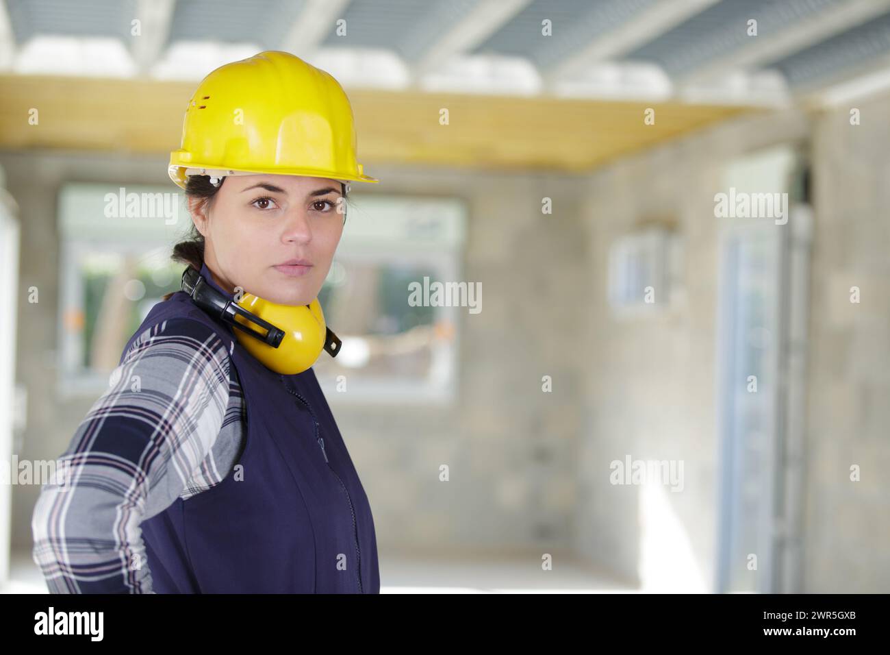 woman is standing serious in a building Stock Photo - Alamy