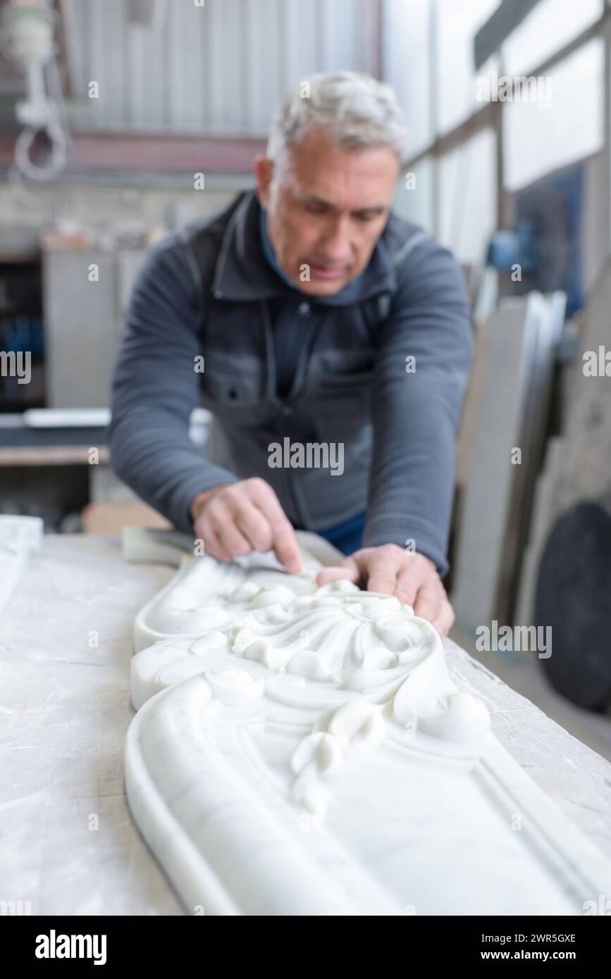 senior sculptor working on his marble sculpture in his workshop Stock ...