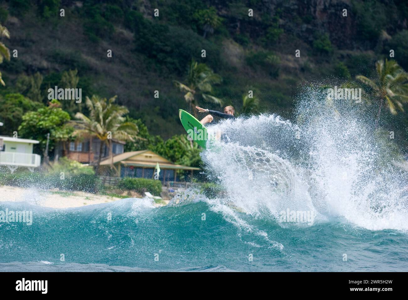A young man performing aerial maneuvers while surfing on the north ...