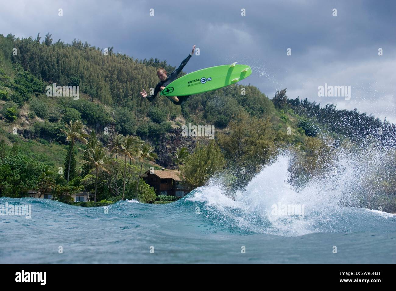 A young man performing aerial maneuvers while surfing on the north ...