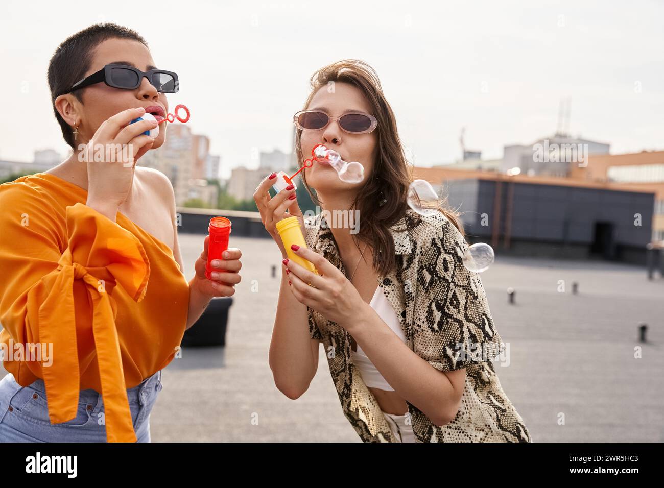 Appealing Young Women In Vibrant Casual Outfits With Sunglasses Blowing