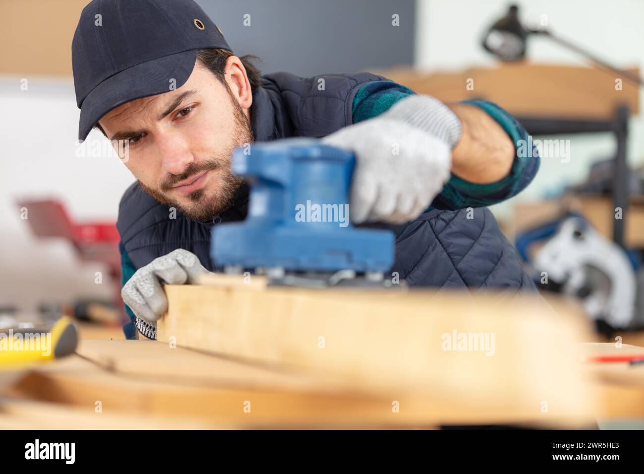 carpenter at work polishing wood using orbit sander Stock Photo - Alamy