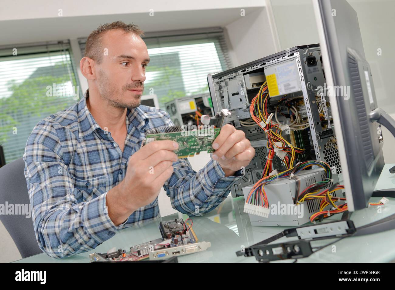 a man is fixing computer Stock Photo - Alamy