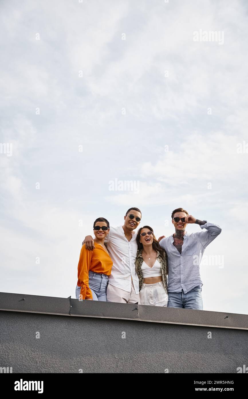 four diverse jolly friends with sunglasses in vivid attires posing on ...