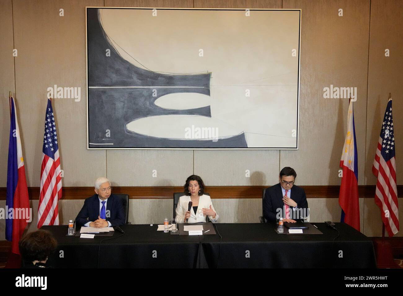 U.S. Commerce Secretary Gina Raimondo, centrt, gestures beside ...