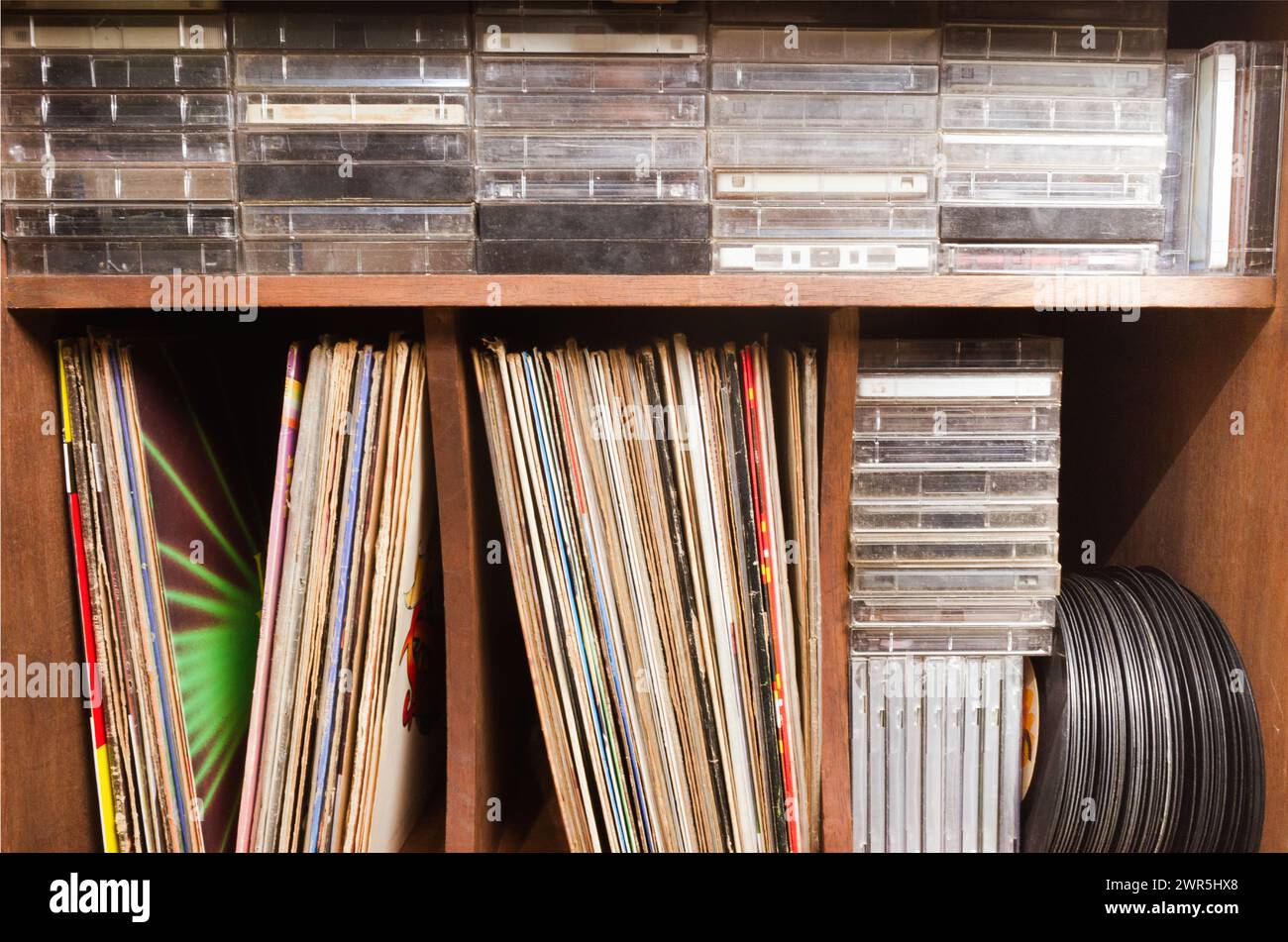 Vinyl disc, compact discs and cassettes on old furniture. Retro Stock ...