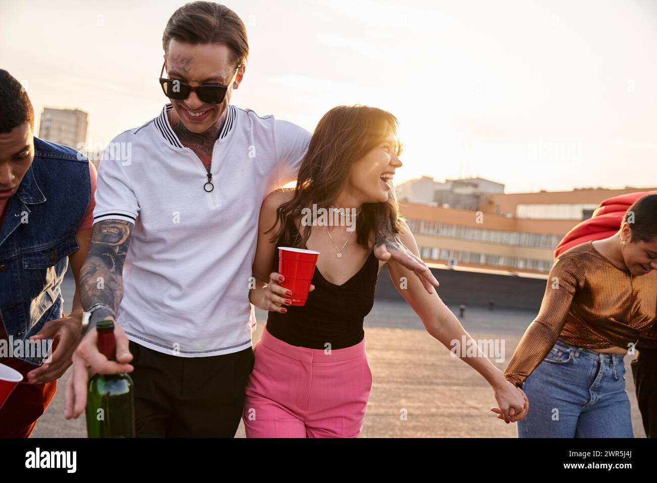 drunk cheerful diverse friends in vibrant attires holding alcohol ...