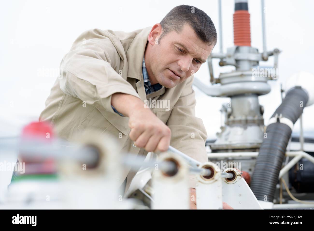 technician using tool to adjust shaft Stock Photo - Alamy