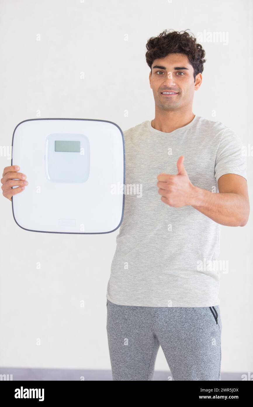 Man standing holding scales hi-res stock photography and images - Alamy