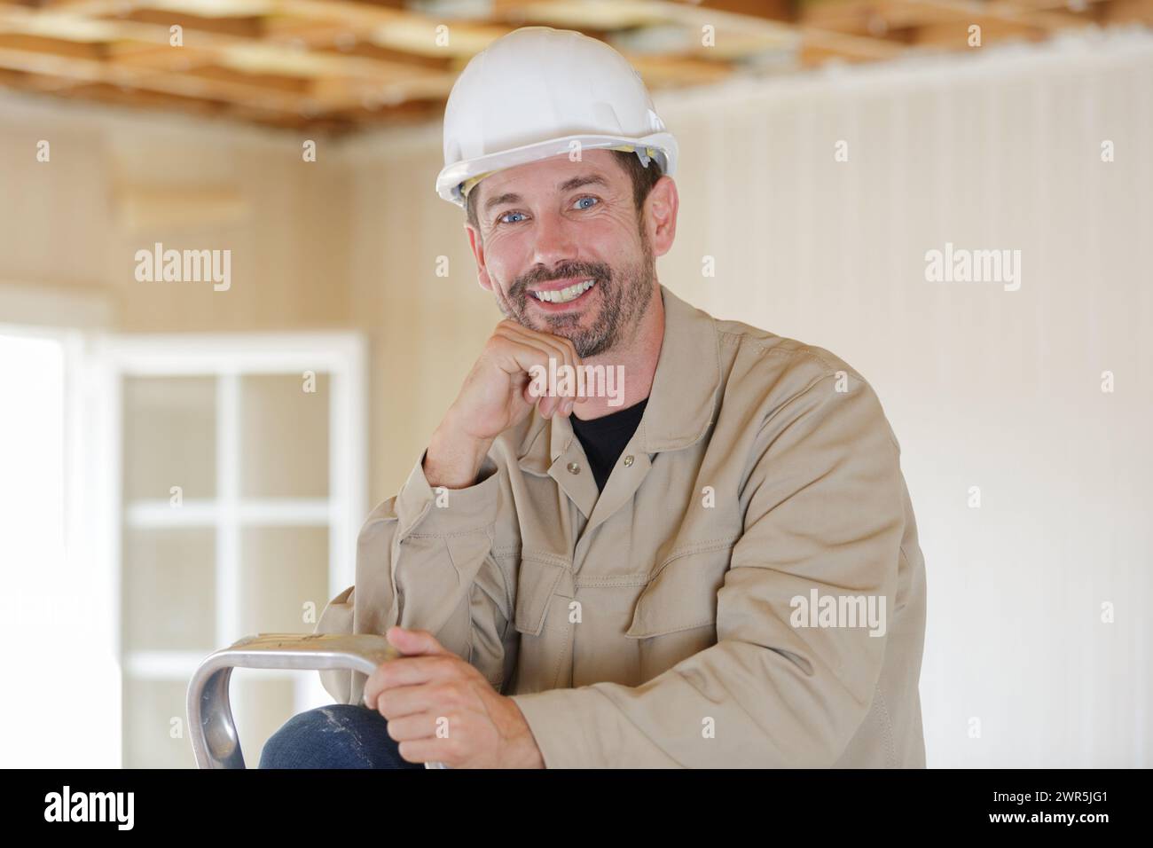 man builder standing in ladder Stock Photo - Alamy