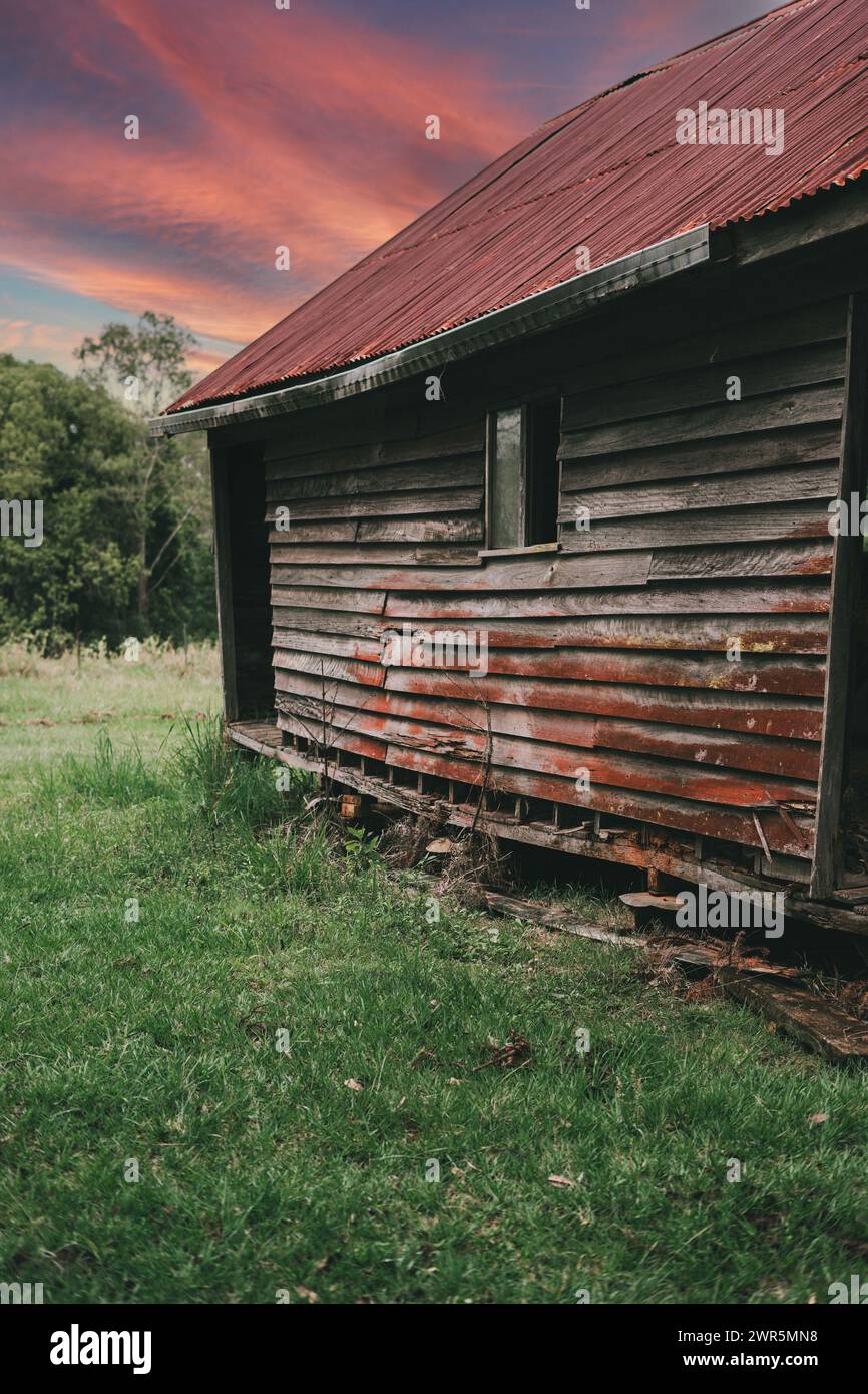 Rural barn at dusk with sun setting behind Stock Photo - Alamy