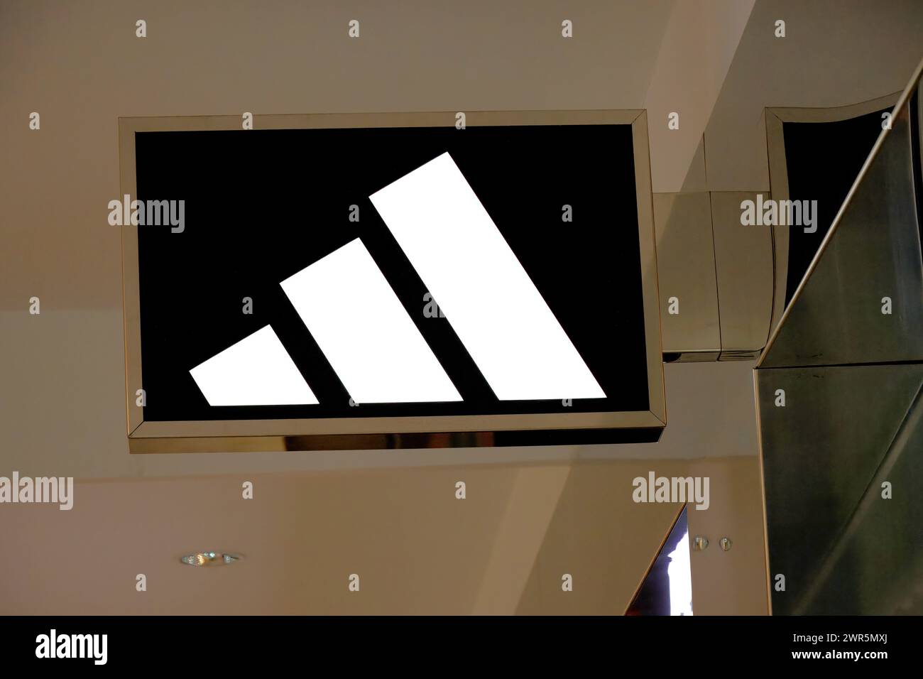 Adidas sign, logo in front of Adidas shop. Adidas is a global sports ...