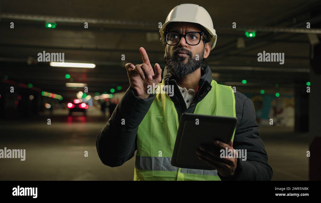 Foreman inspecting parking lot underground urban industrial heavy ...