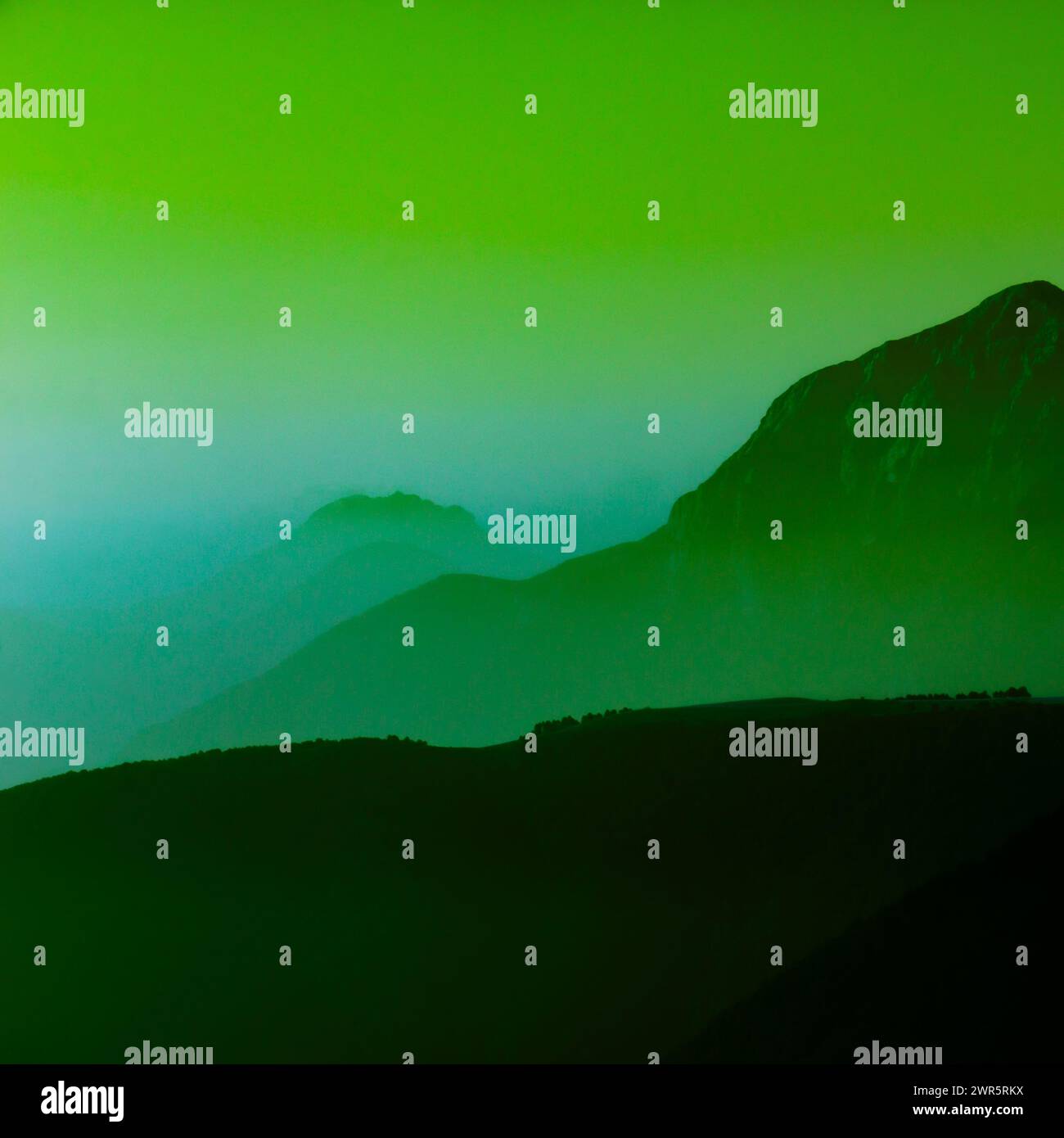 Spectacular mountain ranges silhouettes in shades of green Stock Photo ...