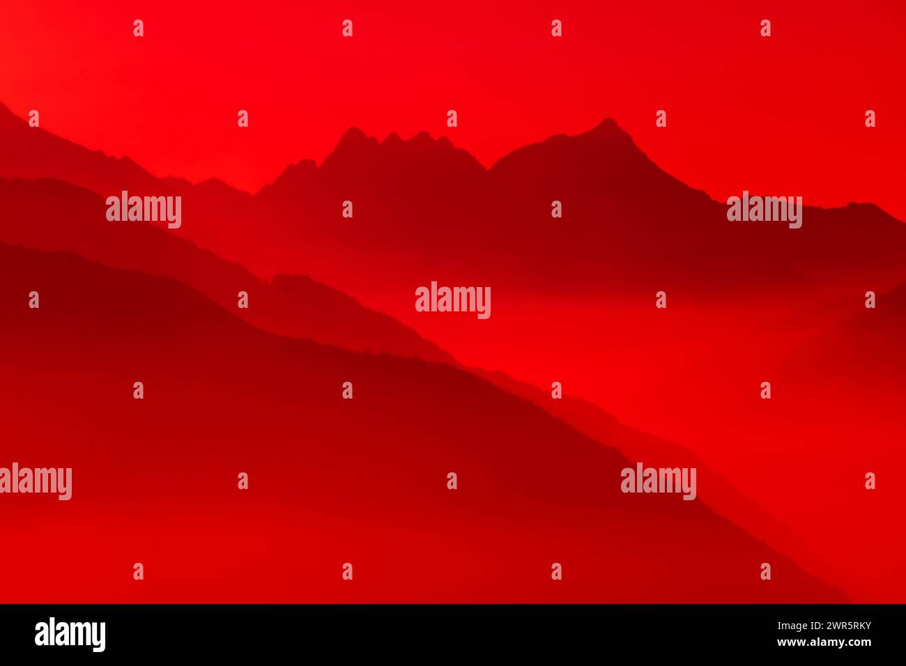 Spectacular mountain ranges silhouettes in shades of red Stock Photo ...