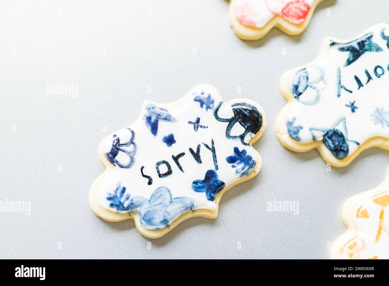 Little Girl Spells 'Sorry' on Iced Sugar Cookies Stock Photo - Alamy