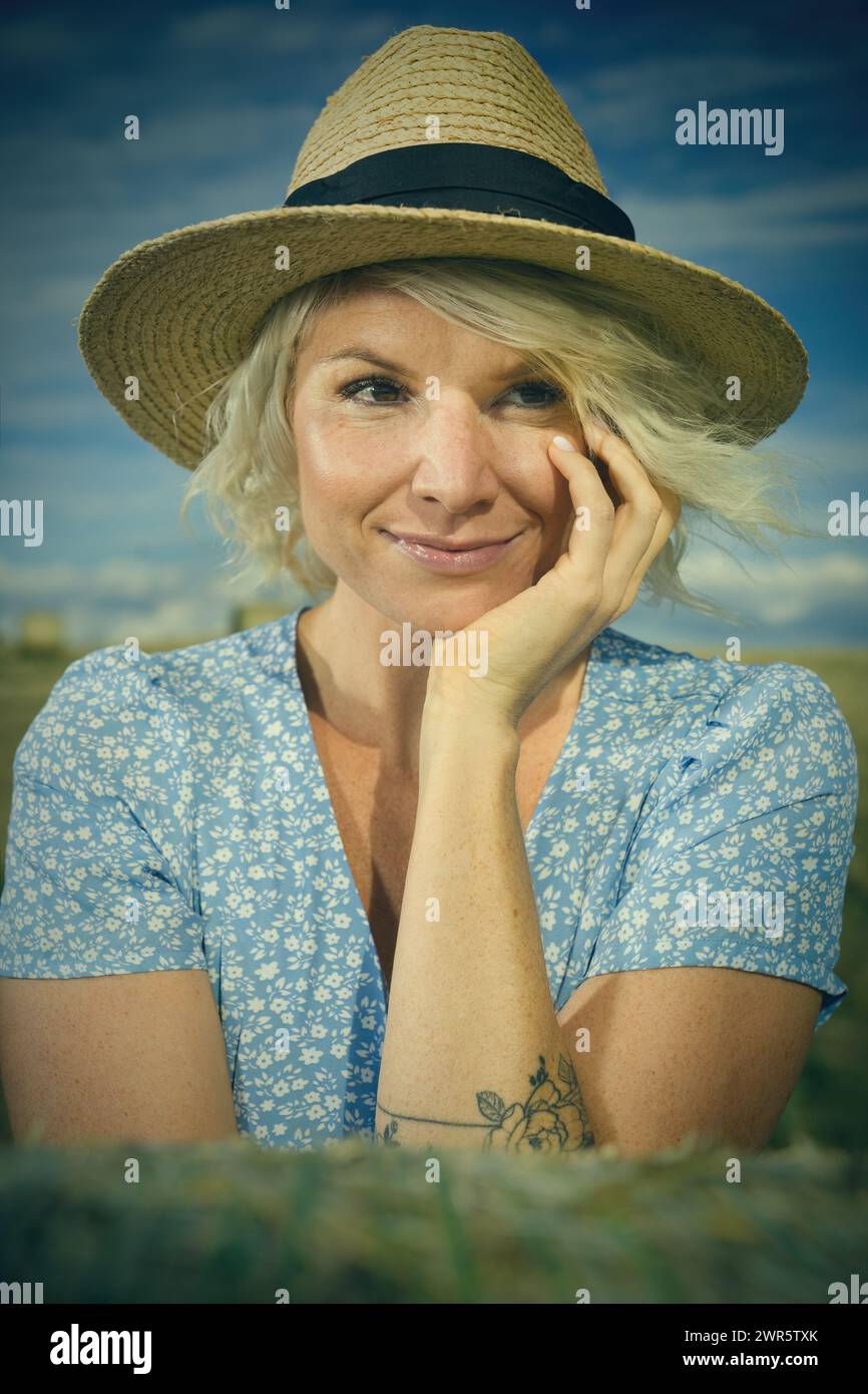 Pretty lady in summer apparel posing on harvested cornfield Stock Photo ...
