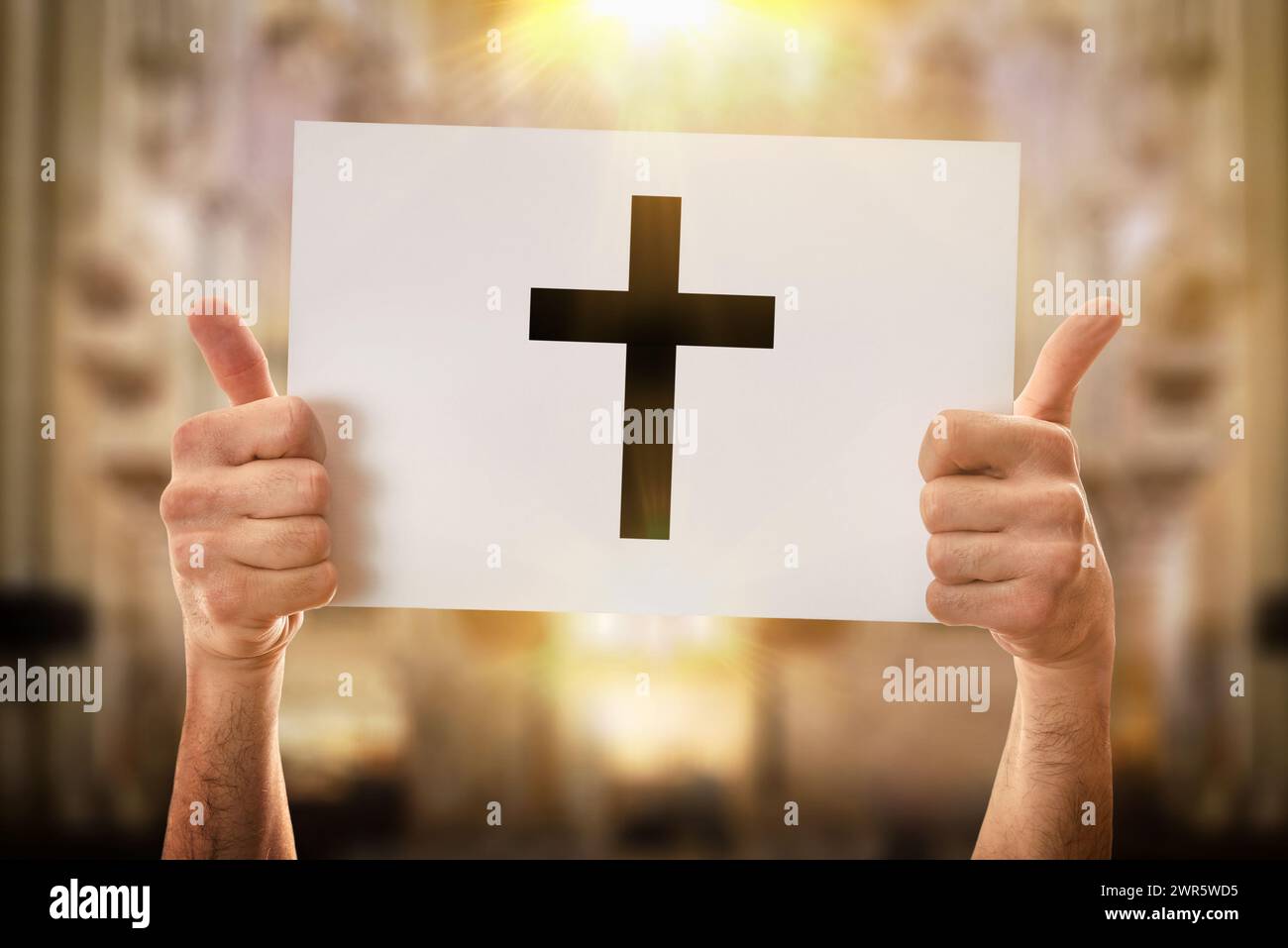 Hands of a religious man with okay sign holding a white poster with ...