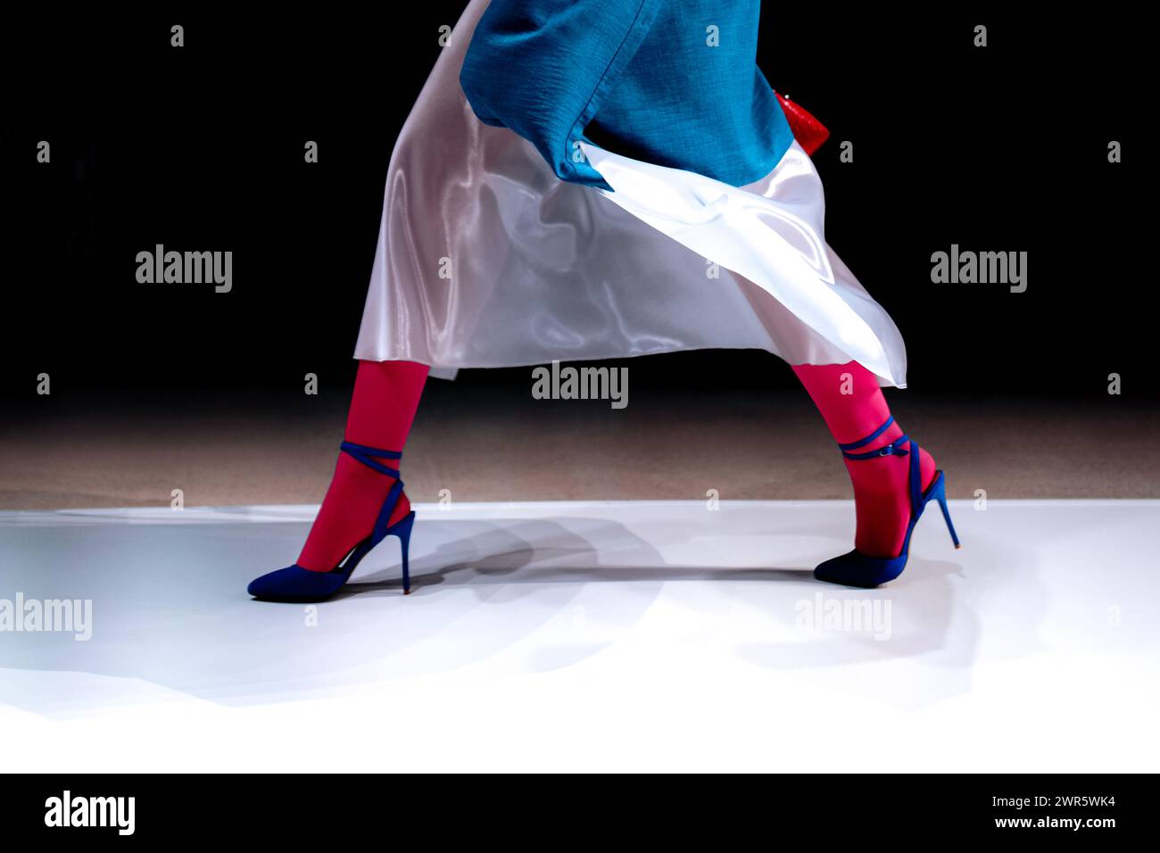 Trendy women's look silky white skirt, pink tights and blue high heels ...