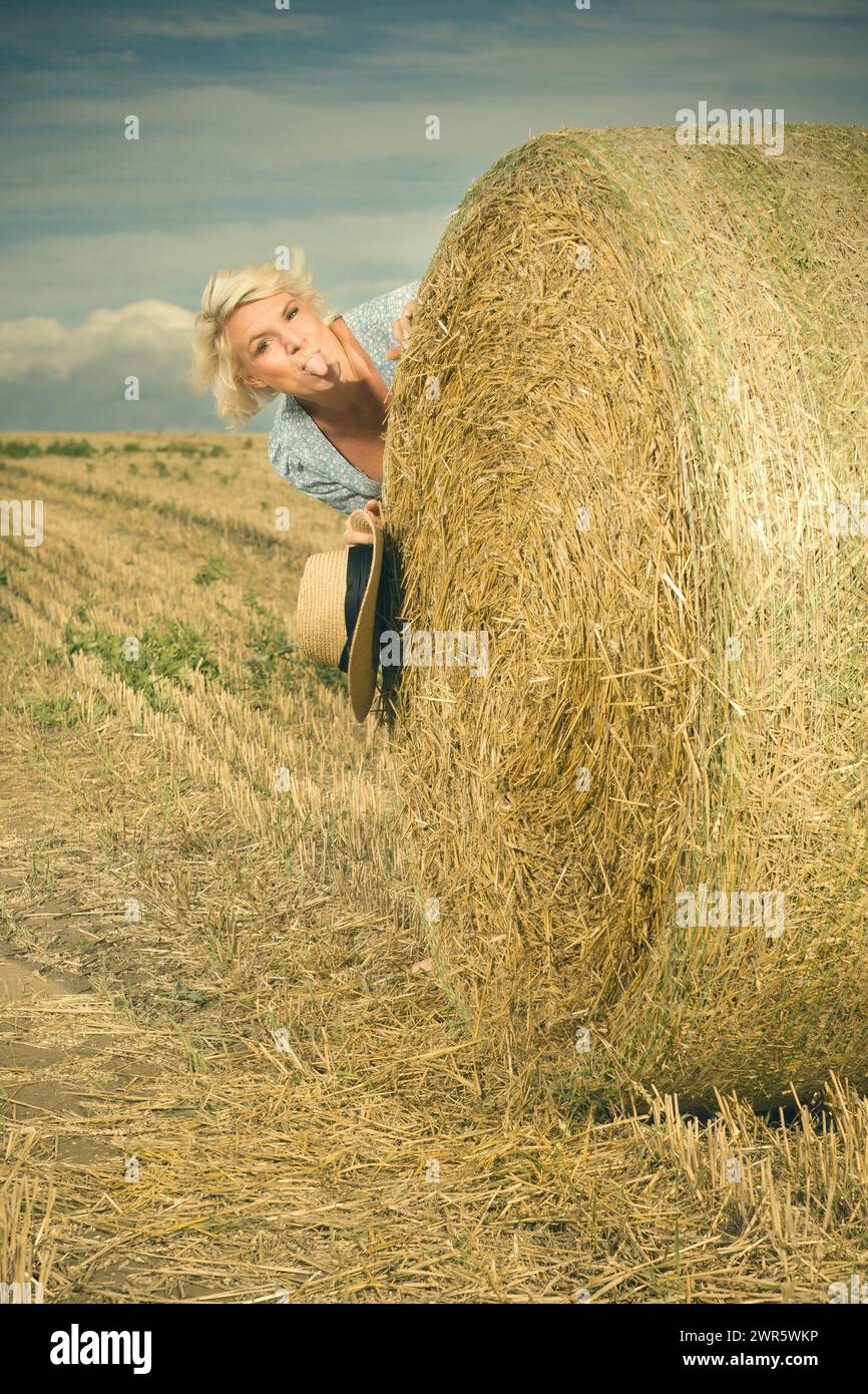 Pretty lady in summer apparel posing on harvested cornfield Stock Photo ...