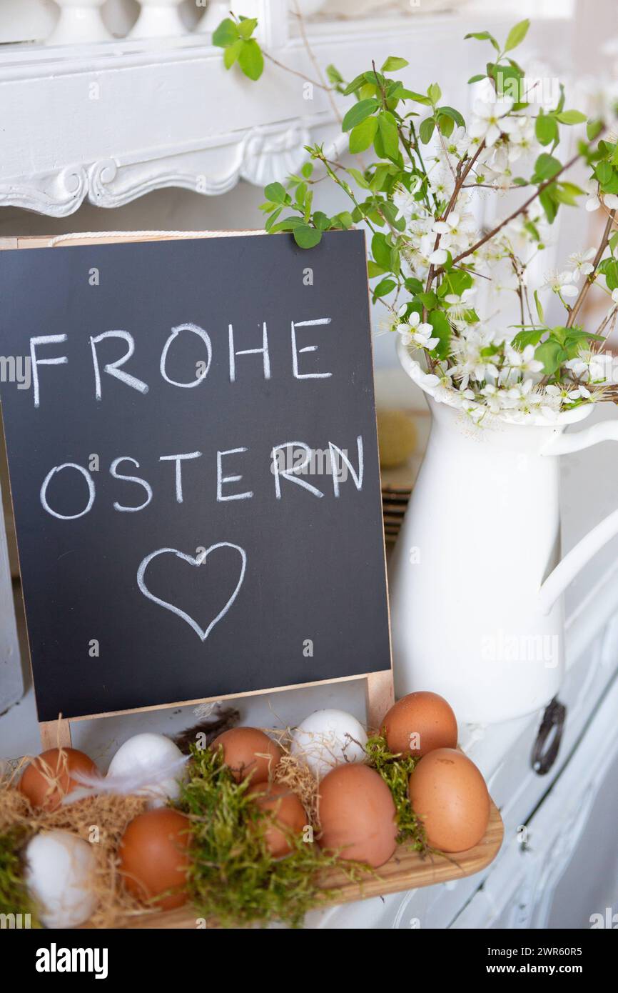 9 March 2024: Happy Easter, greeting on a board surrounded by Easter ...