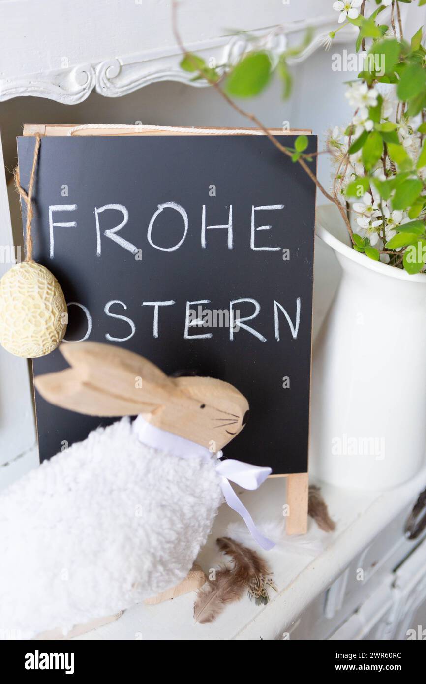 9 March 2024: Happy Easter, greeting on a board surrounded by Easter ...