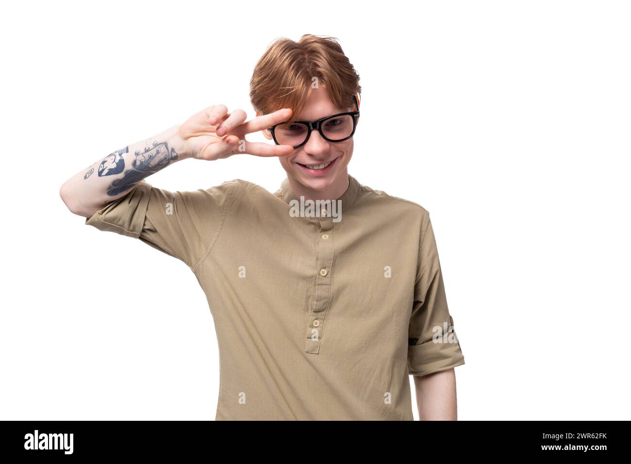 young european slender man with red short hair and a tattoo on his arm ...