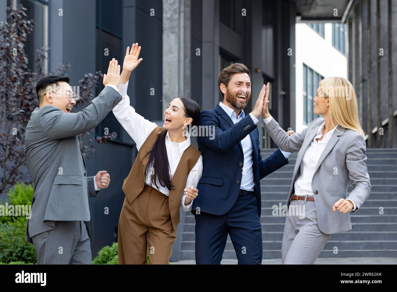 Multiethnic business partners standing outside hi-res stock photography ...