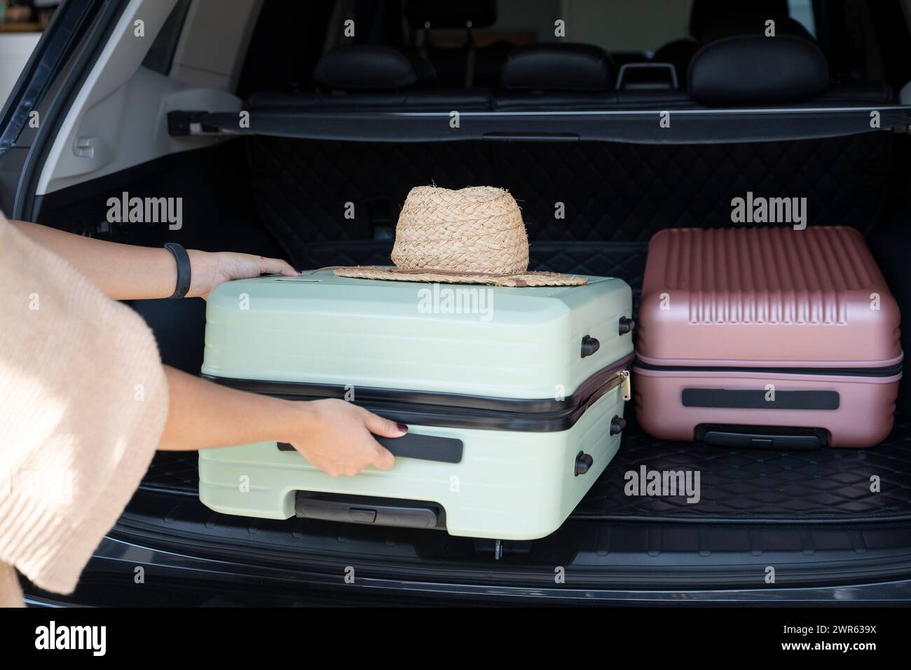 Young woman loading luggage hi-res stock photography and images - Alamy
