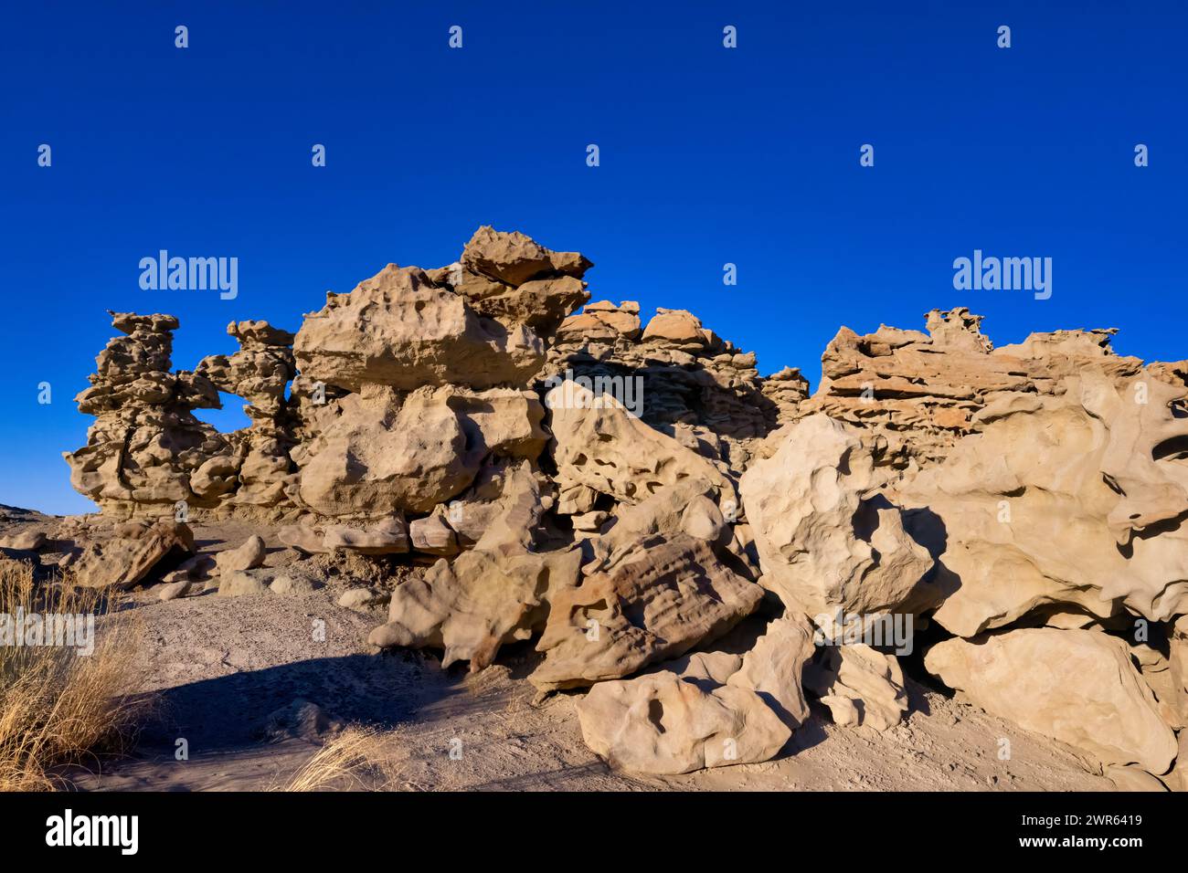 The Smooth sand and towering rock formations in a desert landscape ...