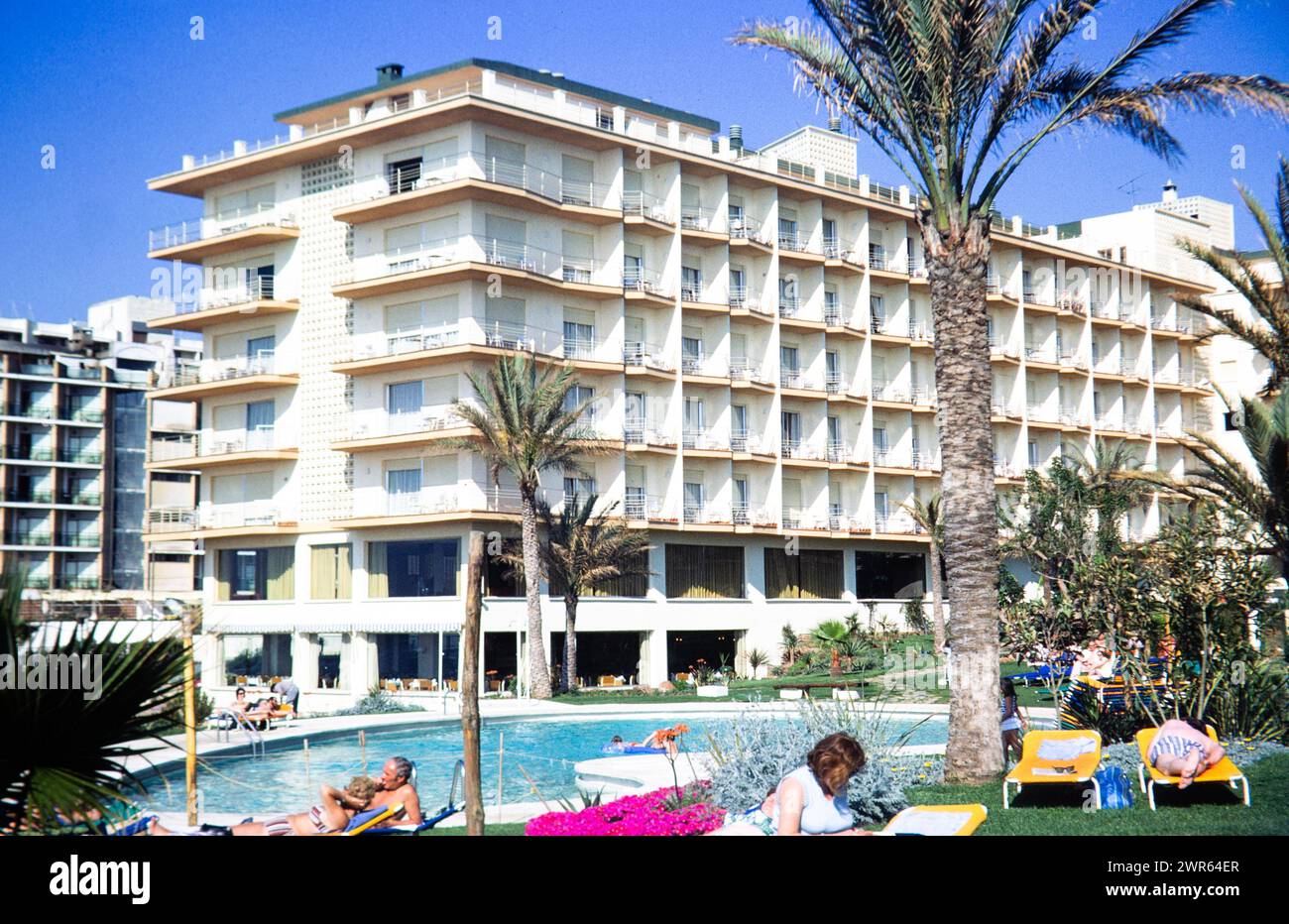 Modern hotel building tourists and swimming pool, 1960s mass tourism ...