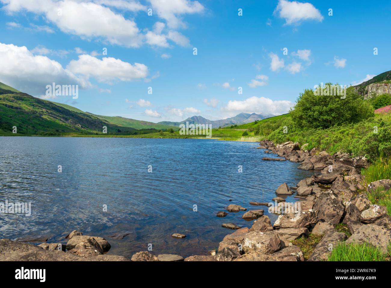 A lake and Mount Snowdon with the surrounding mountain range from ...