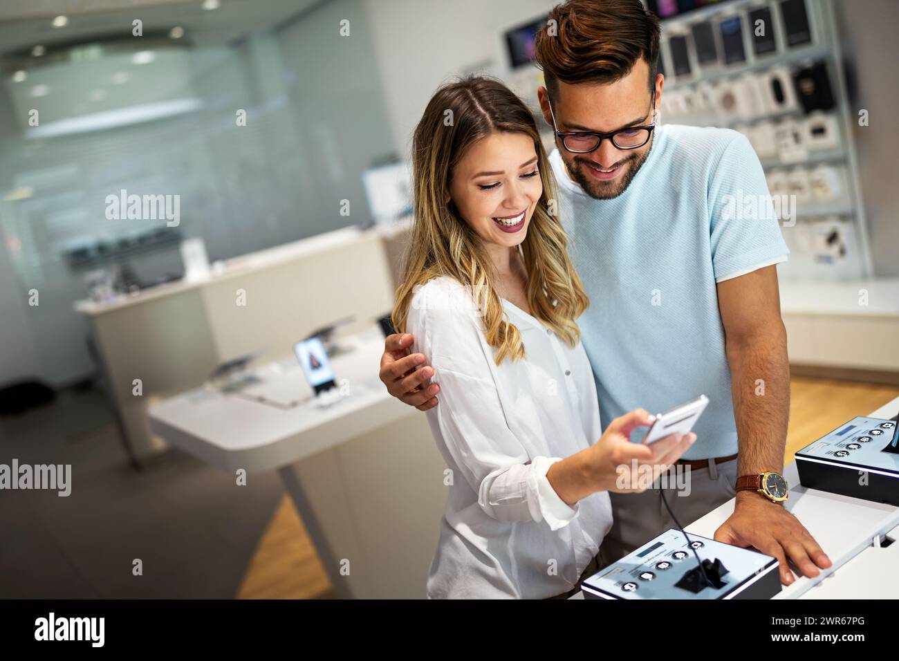 Tech shopping device gadget concept. Happy young people buying a new ...