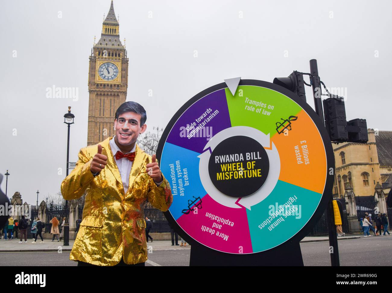 London, UK. 11th March 2024. An actor dressed as Rishi Sunak spins a ...