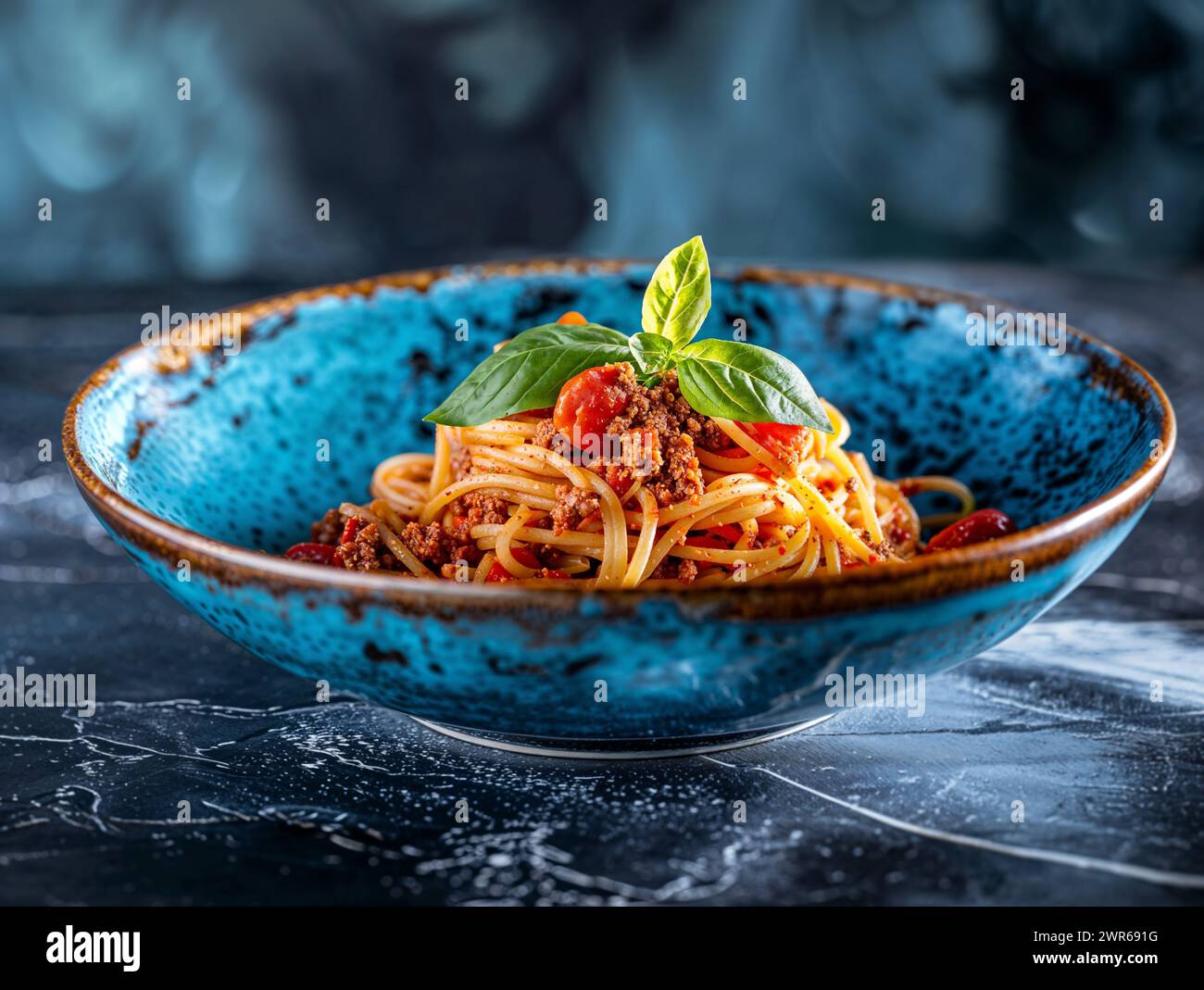Spaghetti Bolognese in modern ceramic bowl on dark slate table Stock ...
