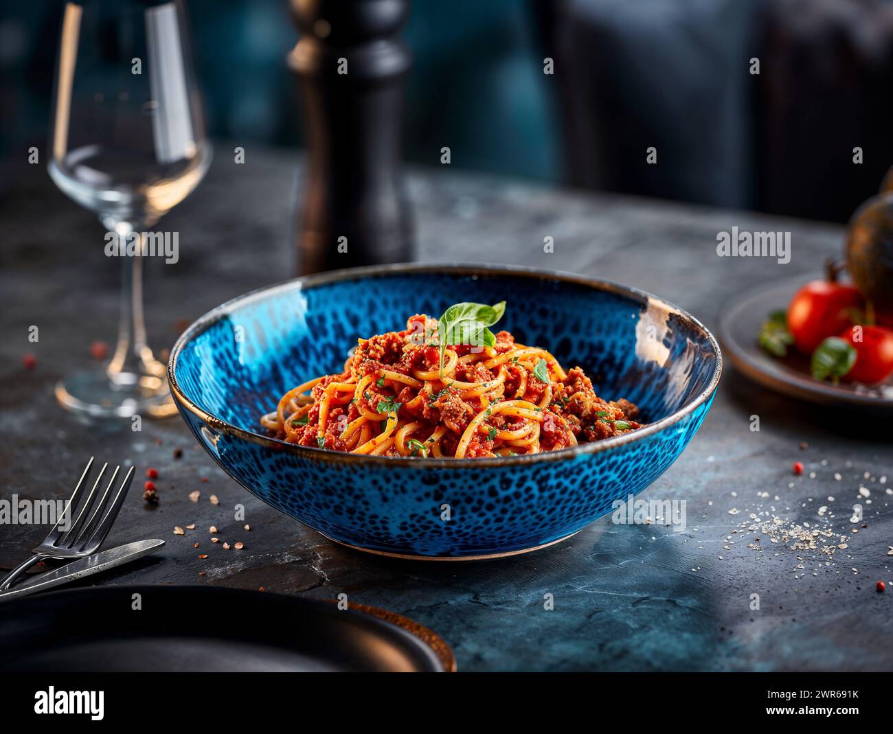 Spaghetti Bolognese in modern ceramic bowl on dark slate table Stock ...