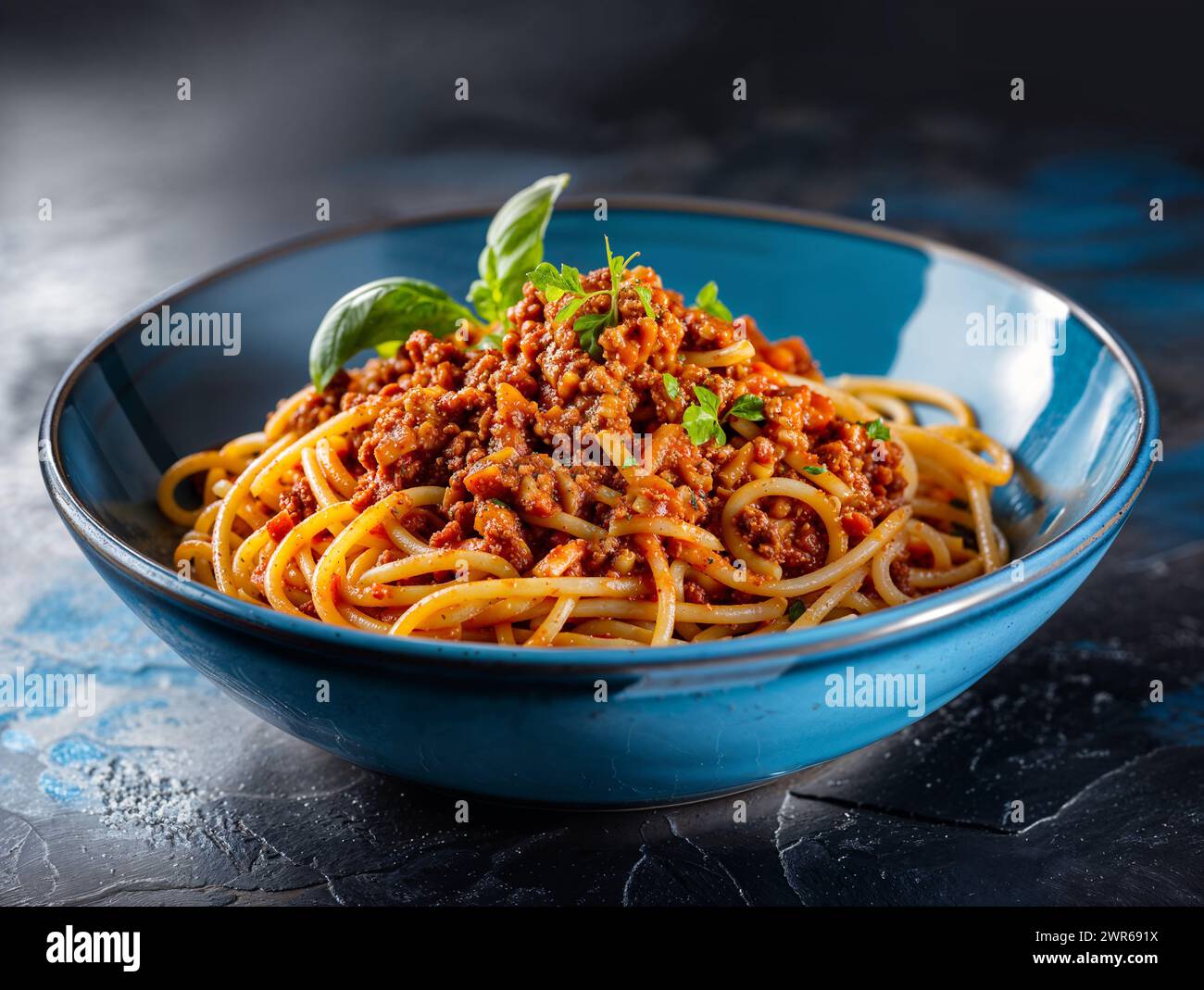Spaghetti Bolognese in modern ceramic bowl on dark slate table Stock ...