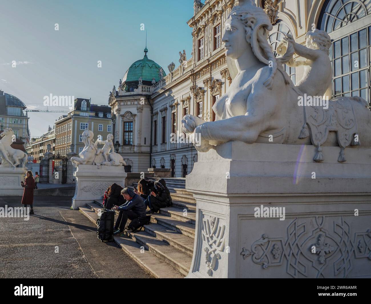 Vienna, Austria. 25th Feb, 2024. Tourists sit on the steps of the ...