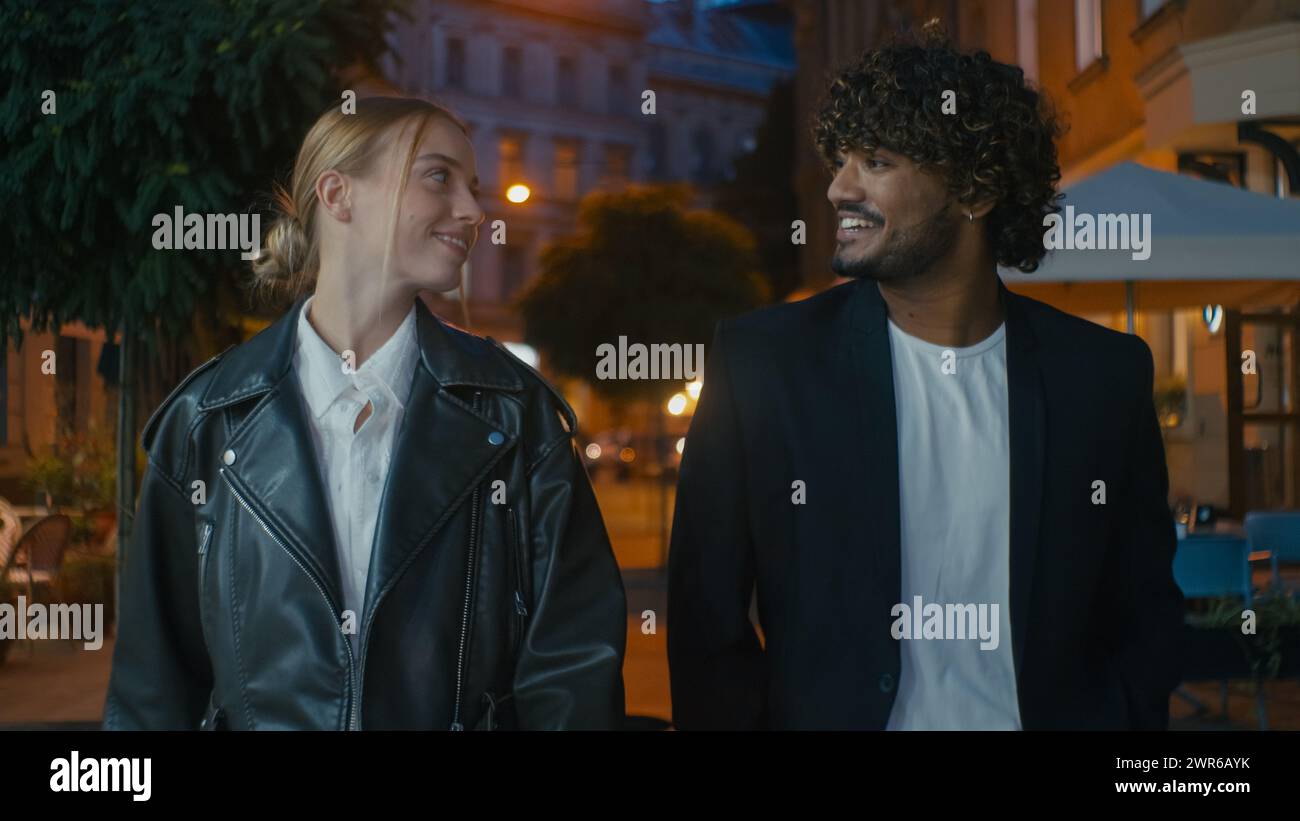 Couple Indian Latino Arabian man and European woman walking city center ...